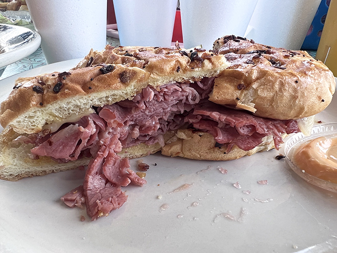 Pastrami piled so high it deserves its own zip code. The kind of sandwich that requires both hands and possibly a nap afterward.