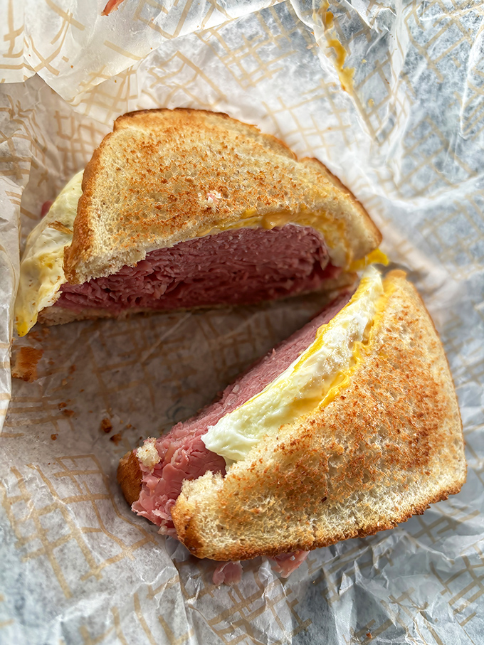 This isn't just a sandwich; it's an engineering marvel of meat architecture. The corned beef is stacked higher than Cleveland's skyline.
