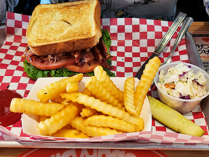 This sandwich isn't just lunch&mdash;it's architecture. Layers of savory goodness nestled between perfectly toasted bread with crispy fries standing guard alongside.