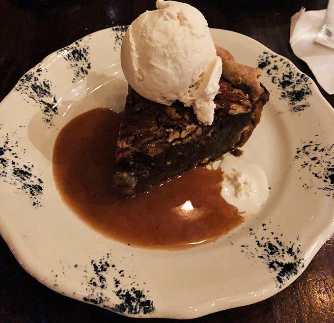 Pecan pie so decadent it should require a permission slip, served with ice cream melting into that warm, sweet abyss of nutty perfection.