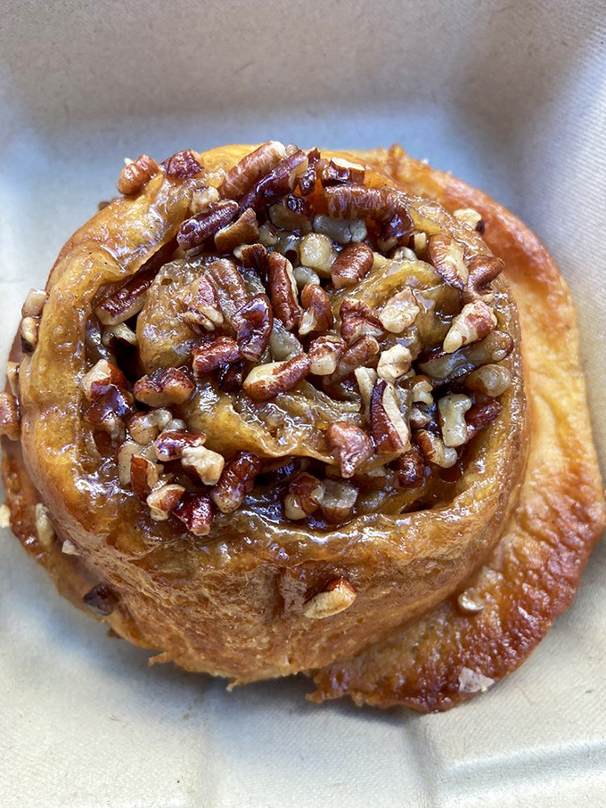 This isn't just a pecan roll&mdash;it's breakfast architecture, a spiral of cinnamon-scented dough supporting its nutty, caramelized crown.