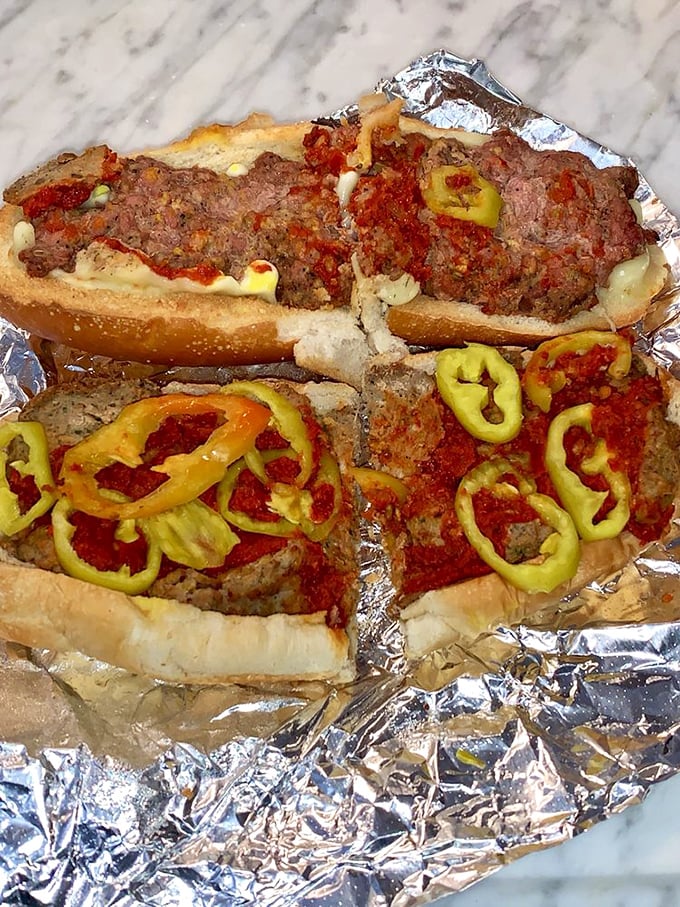 These aren't your average subs—they're architectural marvels of meat, sauce, and banana peppers that demand to be devoured immediately.