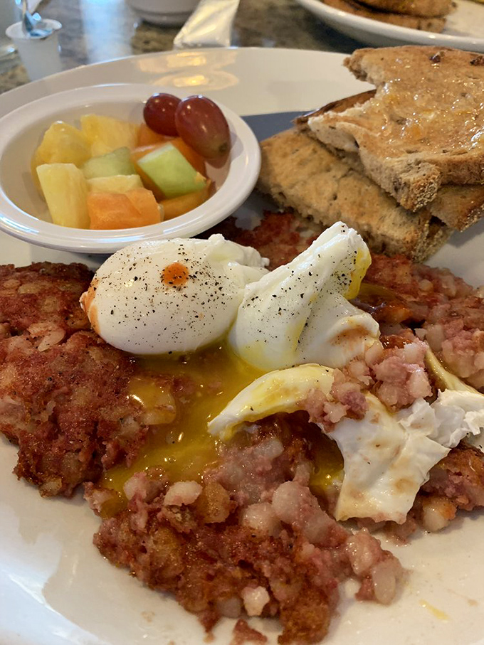 The holy grail of breakfast: perfectly poached eggs atop that legendary corned beef hash. This is what breakfast dreams are made of, folks.