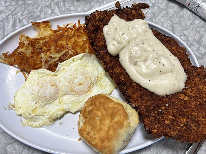 Country-fried perfection meets creamy gravy in a plate that screams "Midwest comfort." Those hash browns aren't playing second fiddle to anyone.