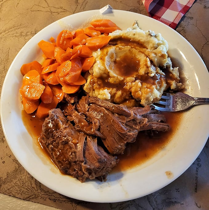 Pot roast that falls apart faster than my willpower around dessert menus, nestled beside those legendary mashed potatoes and glazed carrots.