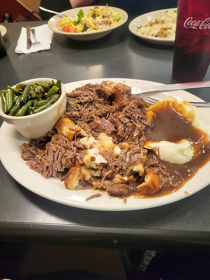 Pot roast that falls apart faster than my resolution to eat light. Those green beans provide the illusion of health while that gravy whispers, "Take a nap later."
