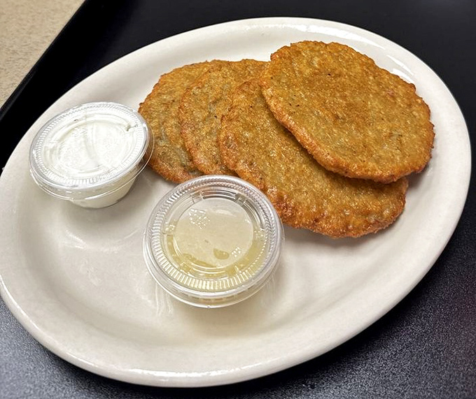 Golden-brown potato pancakes that crackle with each bite, served with the kind of sour cream that makes you forget counting calories was ever invented.
