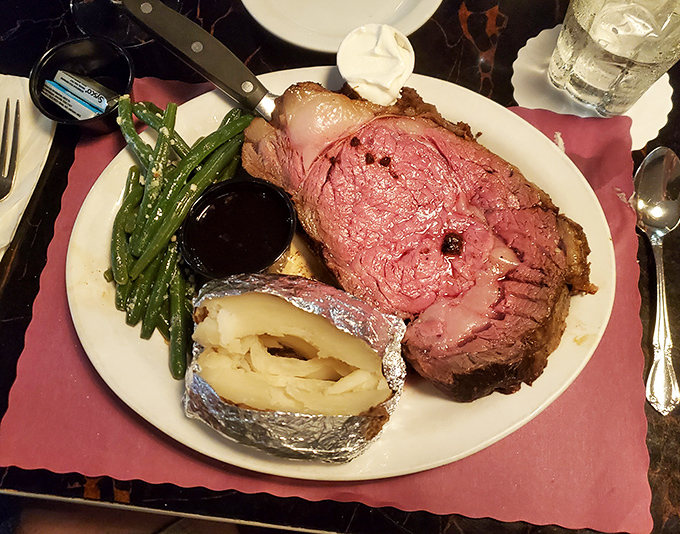 Prime rib so perfectly pink it should be illegal, accompanied by green beans and a potato that's practically begging for butter.