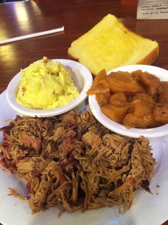 Pulled pork so tender it practically pulled itself. Paired with those sides, it's the holy trinity of comfort food done right.