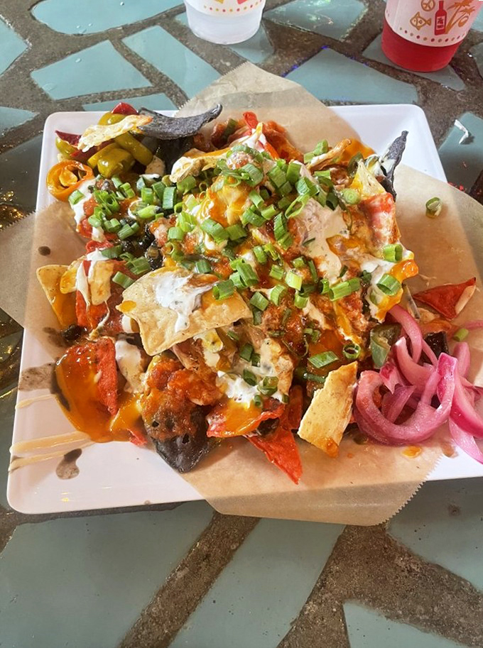 These aren't your ballpark nachos. They're a technicolor flavor explosion topped with enough green onions to make your breath memorable.
