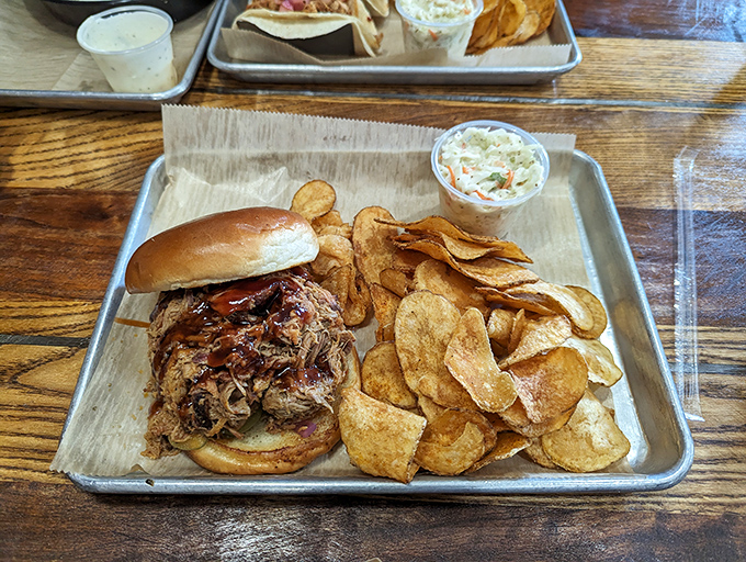 Pulled pork that's had a proper Southern upbringing &ndash; tender, saucy, and served with house-made chips that shatter satisfyingly with each bite.