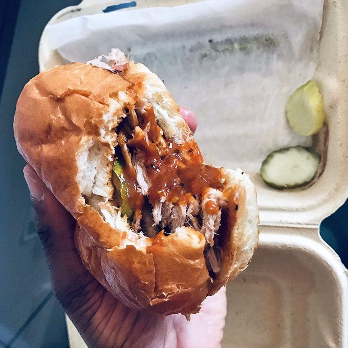 Pulled pork piled high on a brioche bun creates the kind of sandwich that requires both hands.