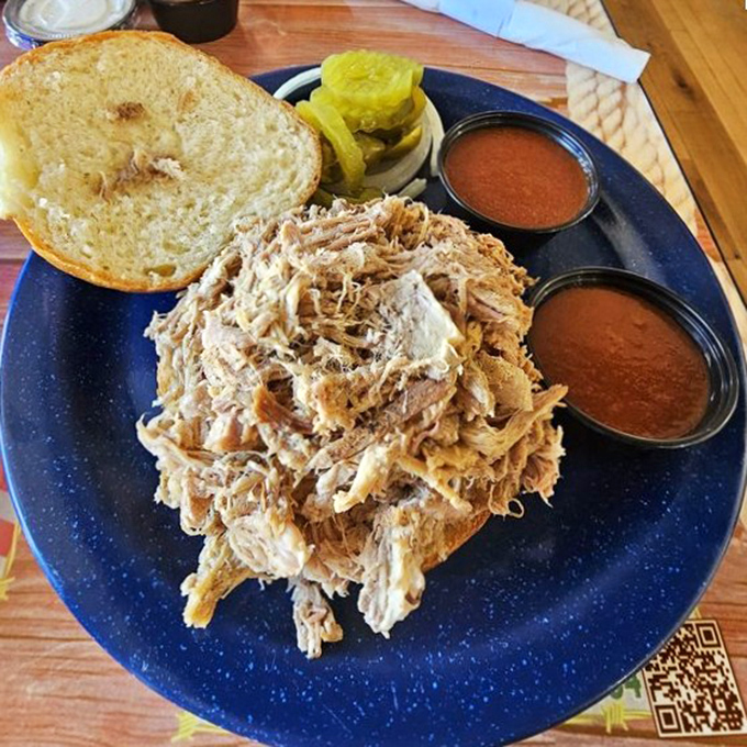 Pulled pork perfection that doesn't need fancy introductions. Just honest barbecue on a bun with pickles and two sauces for customizing your journey to flavor town.