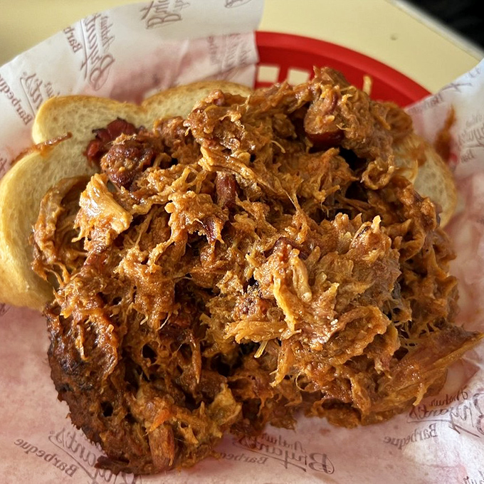 A mountain of pulled pork that's been coaxed into tender submission, piled high on white bread&mdash;simplicity that speaks volumes about barbecue philosophy. 