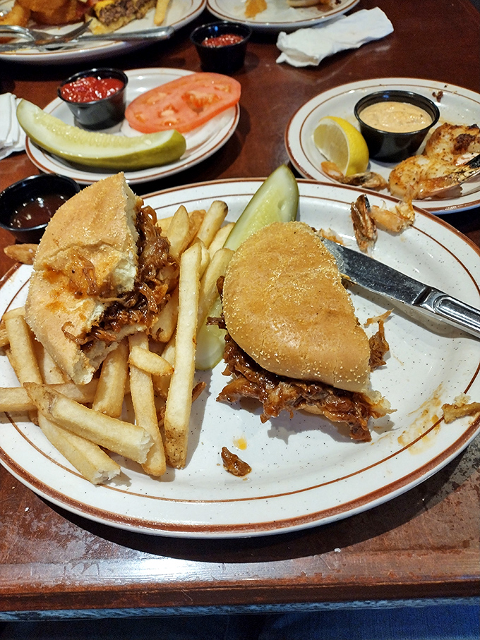 The pulled pork sandwich arrives with golden fries&mdash;a handheld masterpiece that proves simplicity and smoke make the perfect marriage.