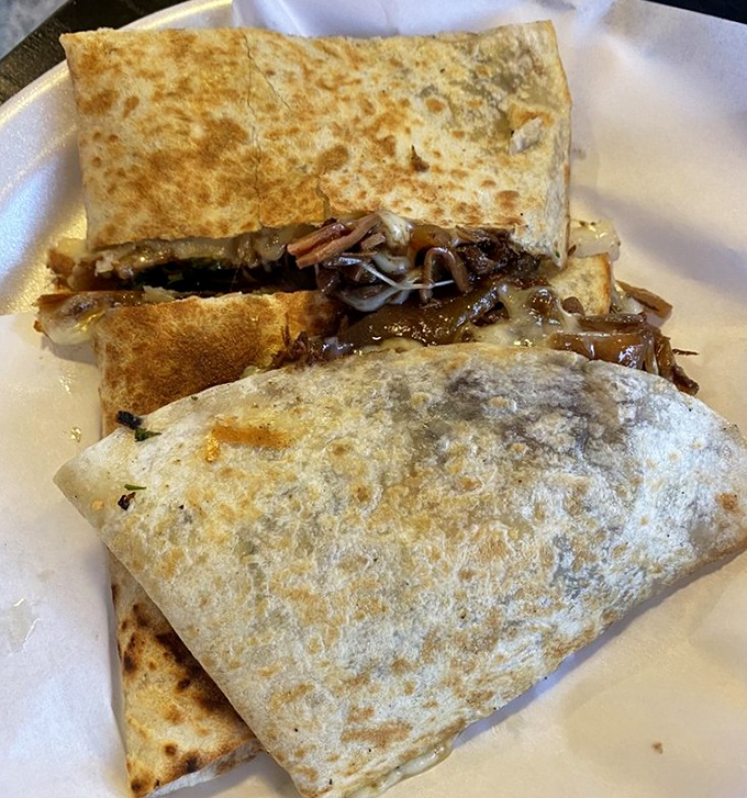 Quesadillas that make you question every other quesadilla you've ever eaten. The golden-brown exterior hides a carnitas-cheese paradise within.