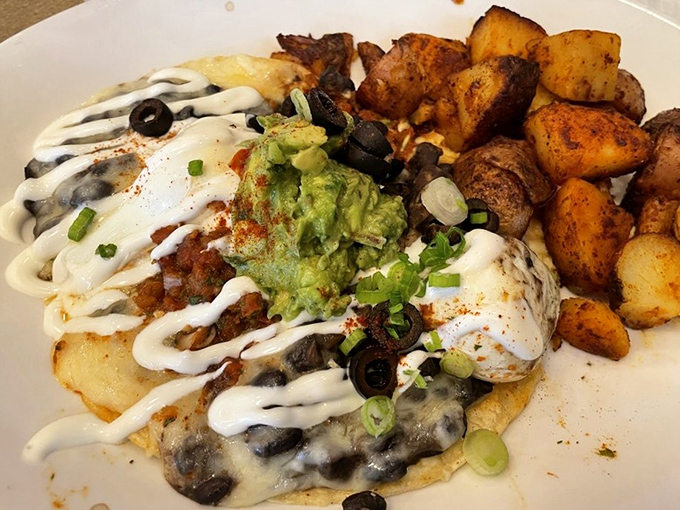 Layer upon layer of breakfast bliss topped with creamy avocado and drizzled with sauce. Architecture you can eat!