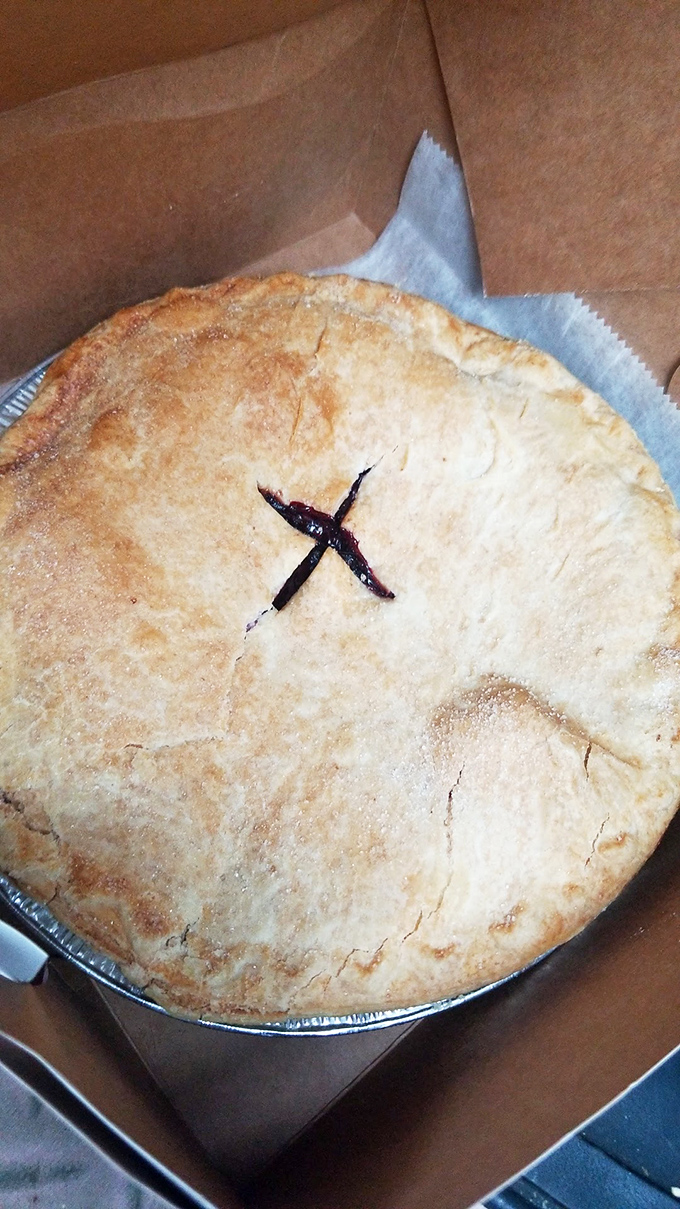 Behold the classic American pie in its natural habitat &ndash; golden crust with that signature "X" marking the spot where fruit filling treasures await.