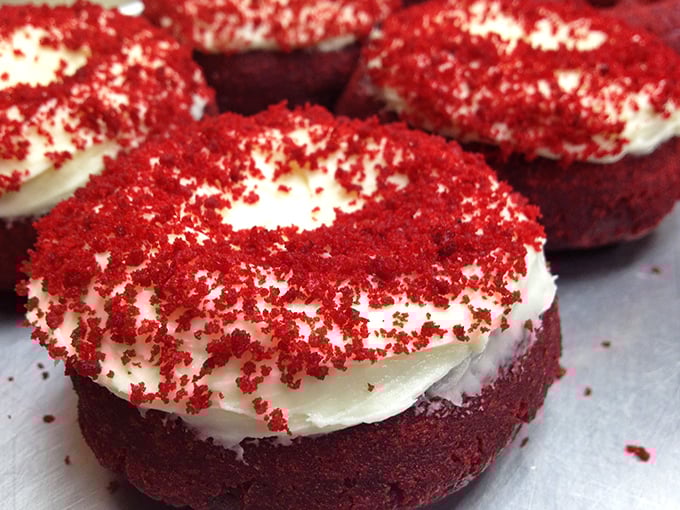 Red velvet donuts with cream cheese frosting – where cake meets donut in a romance so perfect it deserves its own Hollywood movie.