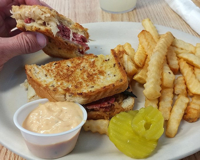 This isn't just a sandwich; it's a Reuben masterpiece with the perfect meat-to-sauerkraut ratio and fries that deserve their own fan club.