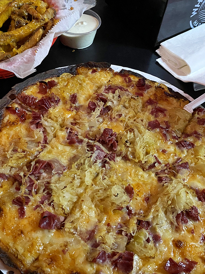 Reuben pizza: the culinary equivalent of "why choose when you can have both?" Sauerkraut and corned beef found their true calling atop melted cheese.