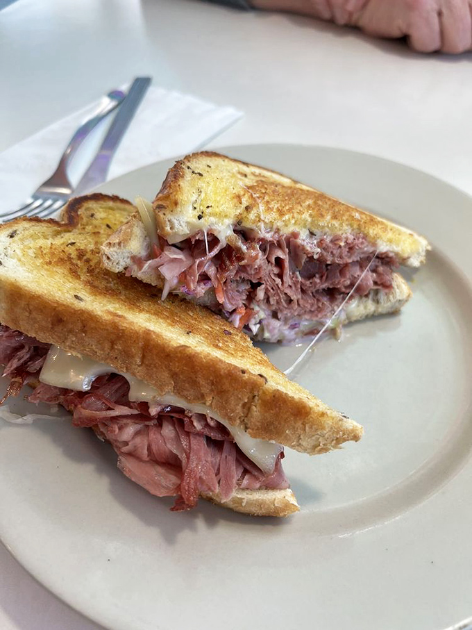 The Reuben sandwich here isn't playing games—it's a serious stack of corned beef that requires both hands and zero distractions.