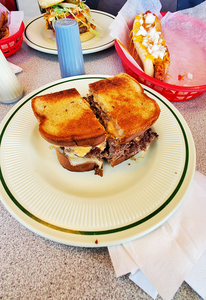 A proper diner patty melt isn't just a sandwich&mdash;it's an architectural achievement. Note the perfect toast-to-filling ratio and strategic cheese melt. 