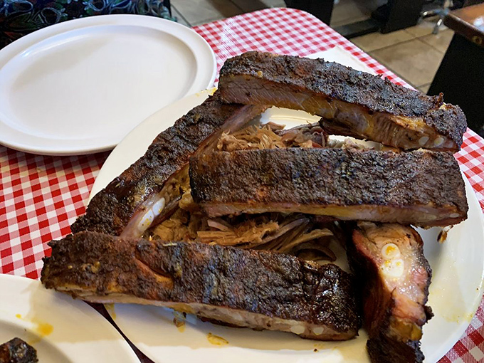 These ribs have that mahogany bark that BBQ dreams are made of—the kind that makes you forget napkins exist until it's too late.