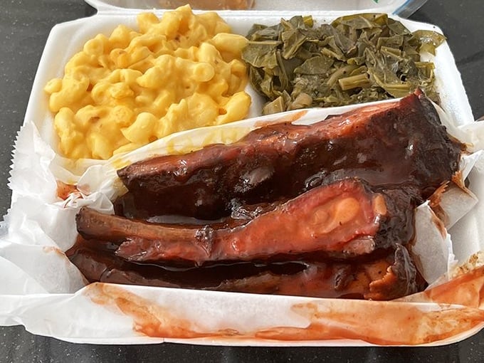 The holy trinity of comfort: fall-off-the-bone ribs, creamy mac and cheese, and collard greens. This isn't a meal; it's an experience.