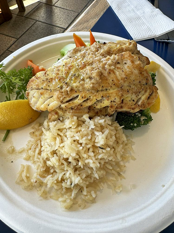 Perfectly grilled rockfish resting on a bed of rice like it's taking a well-deserved vacation. Simple, elegant, and utterly delicious.