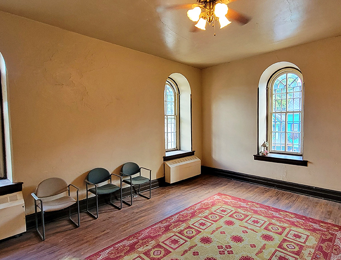 A surprisingly peaceful room within prison walls. The windows let in light but little hope&mdash;architectural poetry in the most tragic sense.