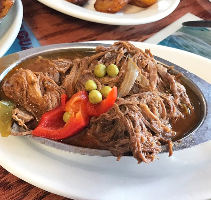 Ropa Vieja&mdash;literally "old clothes"&mdash;but there's nothing threadbare about this succulent shredded beef adorned with peppers like confetti at a flavor parade.