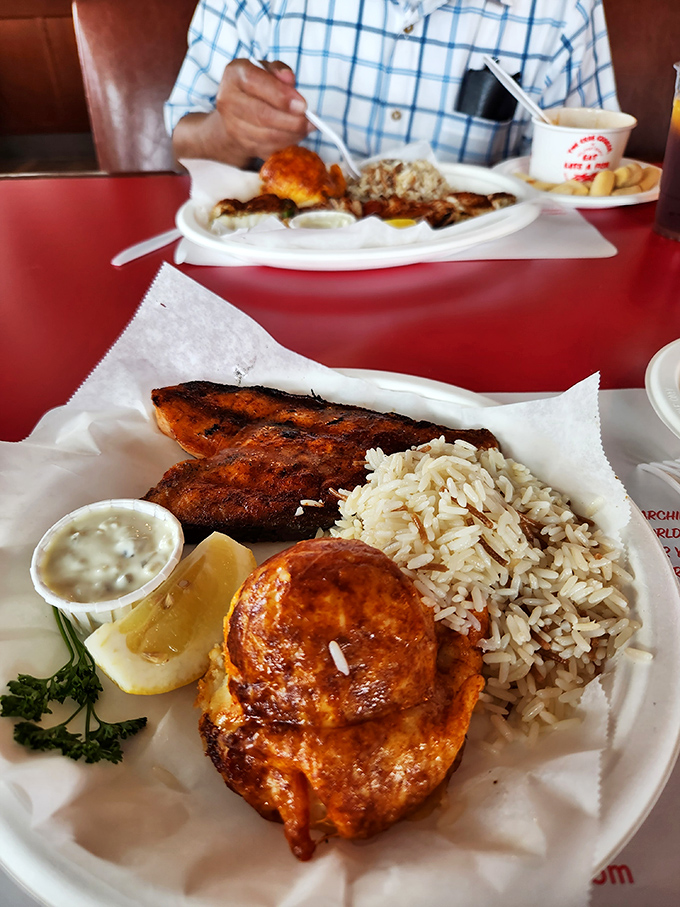The star of the show: mesquite-broiled salmon with that perfect char, served with rice pilaf and a potato that's dressed for a night out.