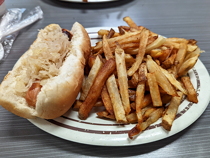 The perfect marriage of tangy sauerkraut and savory dog, with those hand-cut fries playing the role of delicious wedding guests.