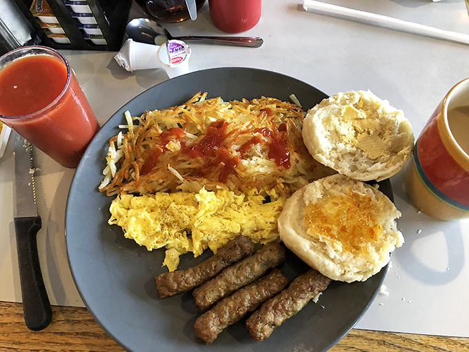 Breakfast of champions: crispy hash browns, fluffy scrambled eggs, savory sausage links, and biscuits that practically beg for gravy.