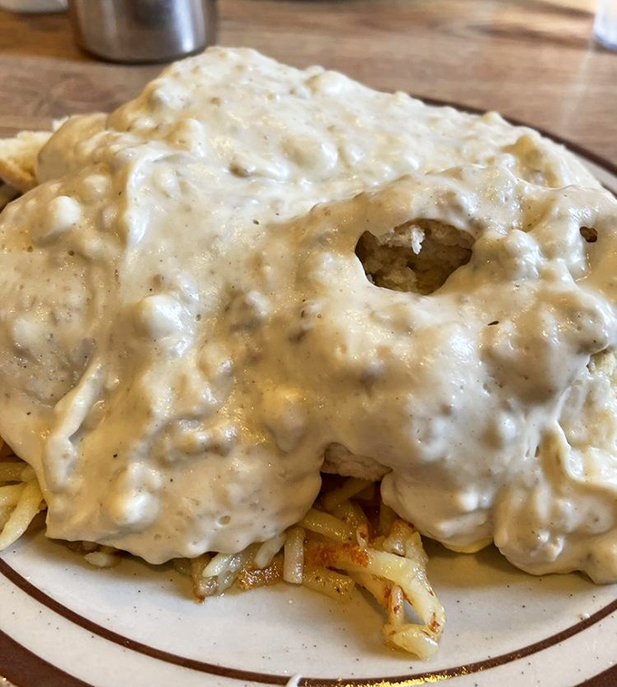The holy grail of breakfast: sausage gravy cascading over golden hash browns. Not all heroes wear capes&mdash;some wear gravy boats and ladles.