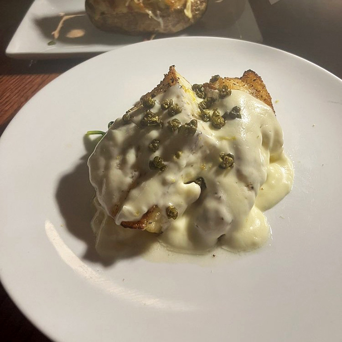 The sea bass arrives wearing a caper cream tuxedo. Ocean-fresh flavor that somehow found its way to landlocked Missouri in spectacular fashion.