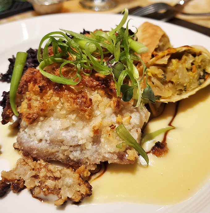 This isn't just fish; it's a masterclass in texture&mdash;crispy exterior giving way to flaky perfection, with spring onions adding a fresh finish.