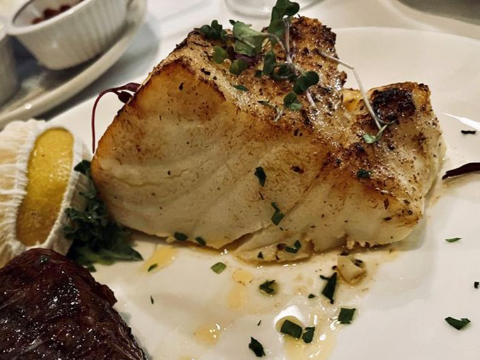 Sea bass that's been seared to such perfection, it's practically showing off while sharing the plate with its beefy companion.