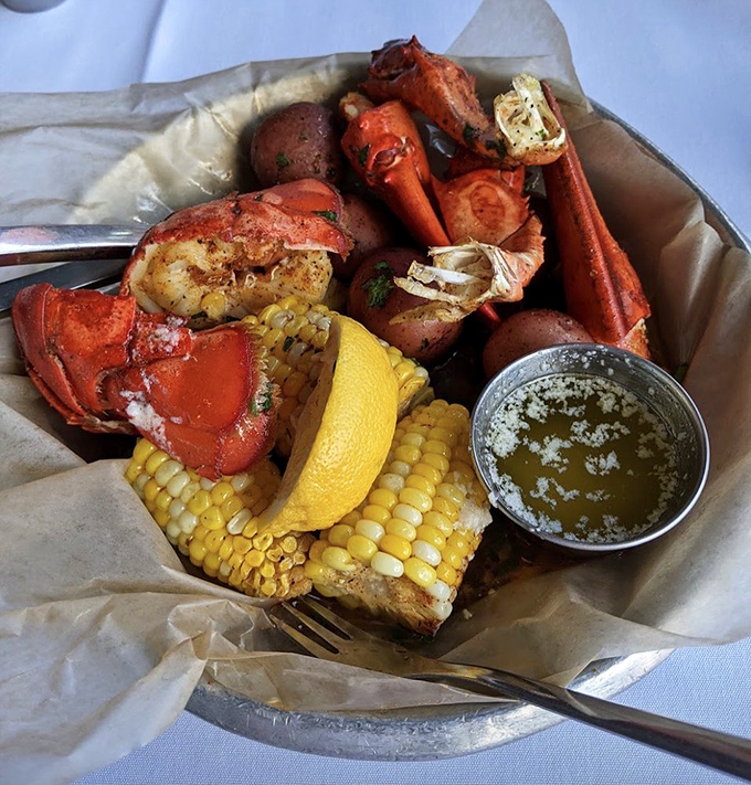 Lobster, corn, and potatoes having the world's most delicious pool party. The butter sauce is basically liquid gold.
