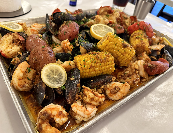 The seafood boil in all its glory: shrimp, mussels, corn, and potatoes swimming in seasoned broth. Napkins required, inhibitions optional.