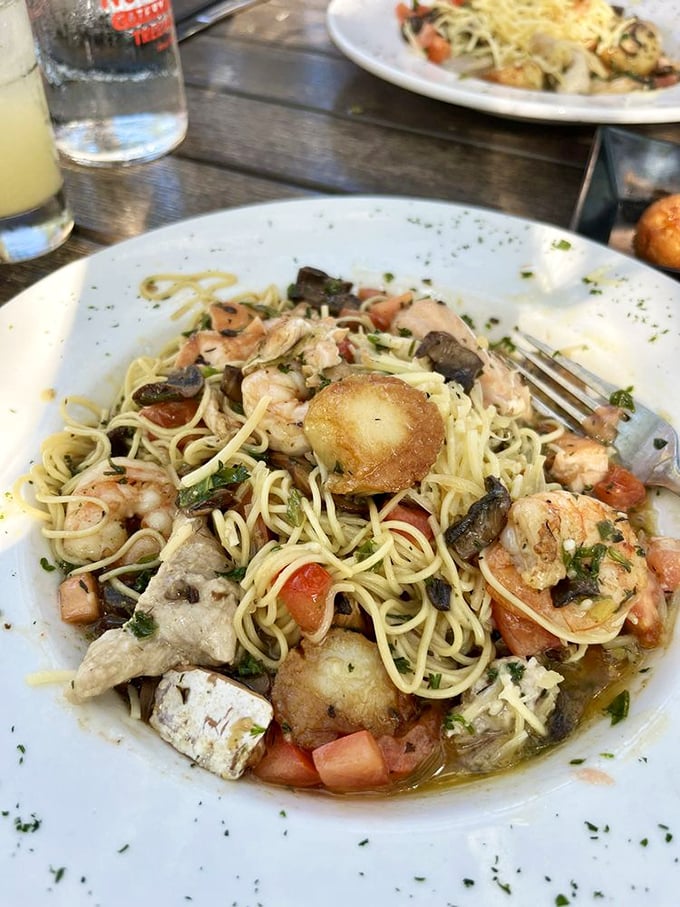 Pasta that's having an identity crisis as an ocean! Shrimp, fish, and scallops swimming in a sea of perfectly twirled noodles.