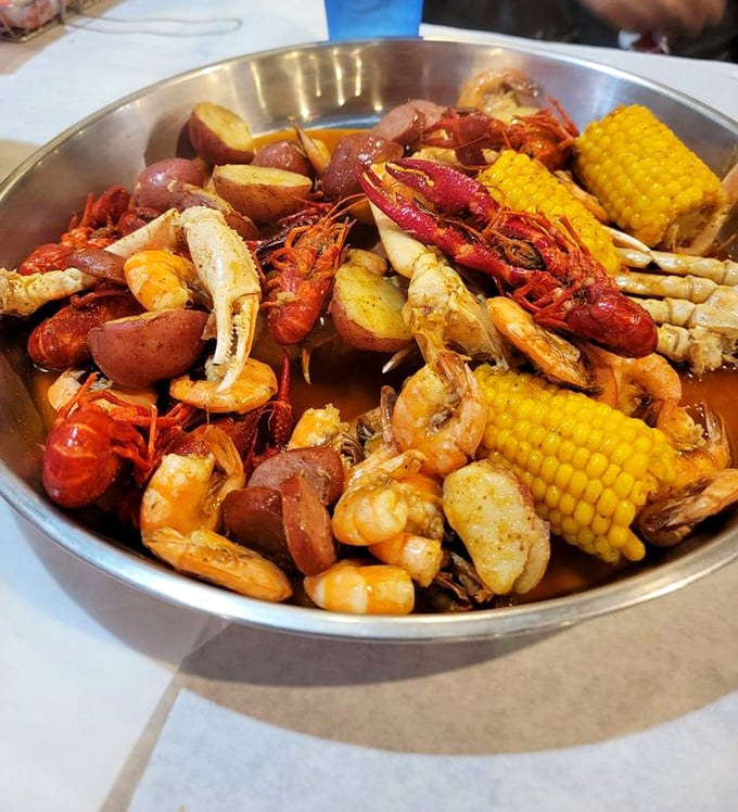 A seafood boil that looks like Neptune's own family reunion, complete with corn, potatoes, and crustacean royalty.