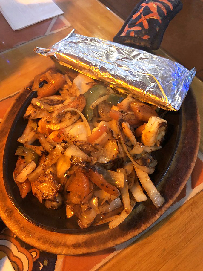 Seafood fajitas that arrive still cooking – the sizzle providing both soundtrack and aromatherapy for what's about to become your new food obsession.