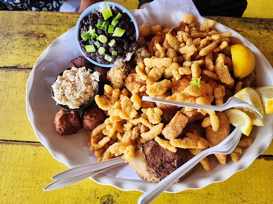 The seafood platter that launched a thousand return visits. Black beans, coleslaw, hush puppies, and enough fried goodness to make Neptune jealous.