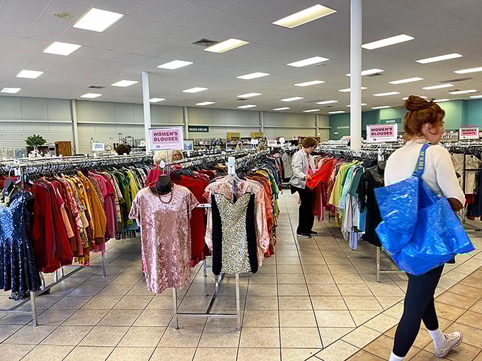 Serious shoppers navigate the well-organized women's section with the focus of archaeologists on the brink of a major discovery.