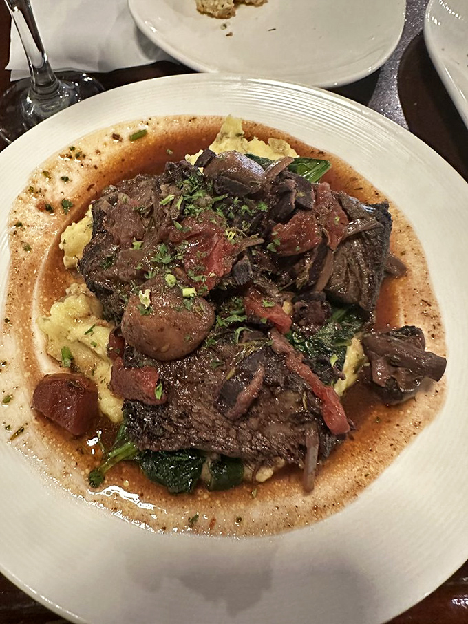 Short ribs so tender they practically surrender at the sight of your fork, swimming in a sauce that deserves its own fan club.