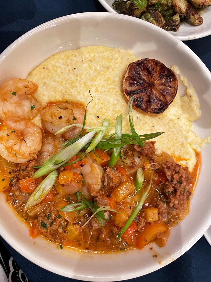 Shrimp and grits: the dish that proves the South won the flavor wars. Creamy yellow cornmeal cradling plump shrimp and that saucy situation below? Pure poetry.