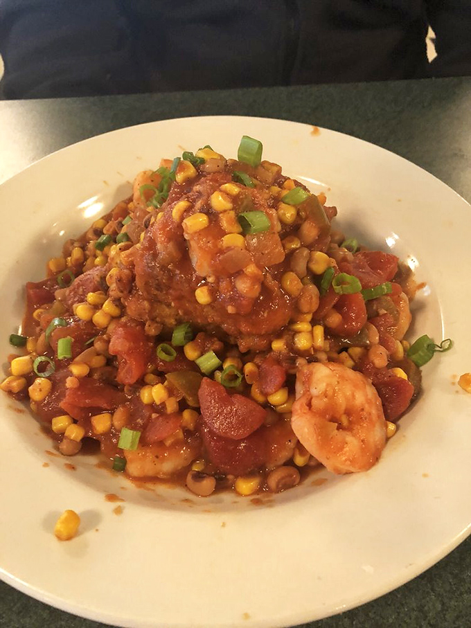 Shrimp and grits with enough color to make an artist jealous. Those plump shrimp nestled in tomatoes and corn create a Southern symphony.
