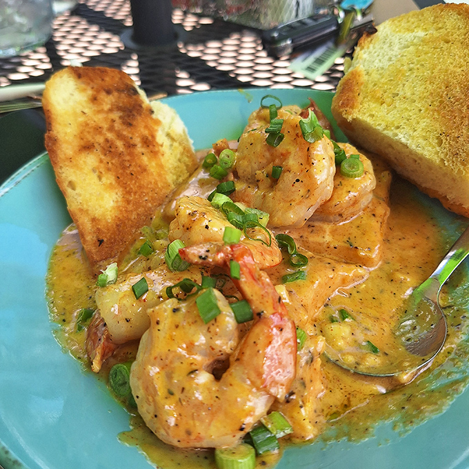 The shrimp and grits arrive swimming in a sauce so good you'll be plotting ways to smuggle it home in your water bottle.
